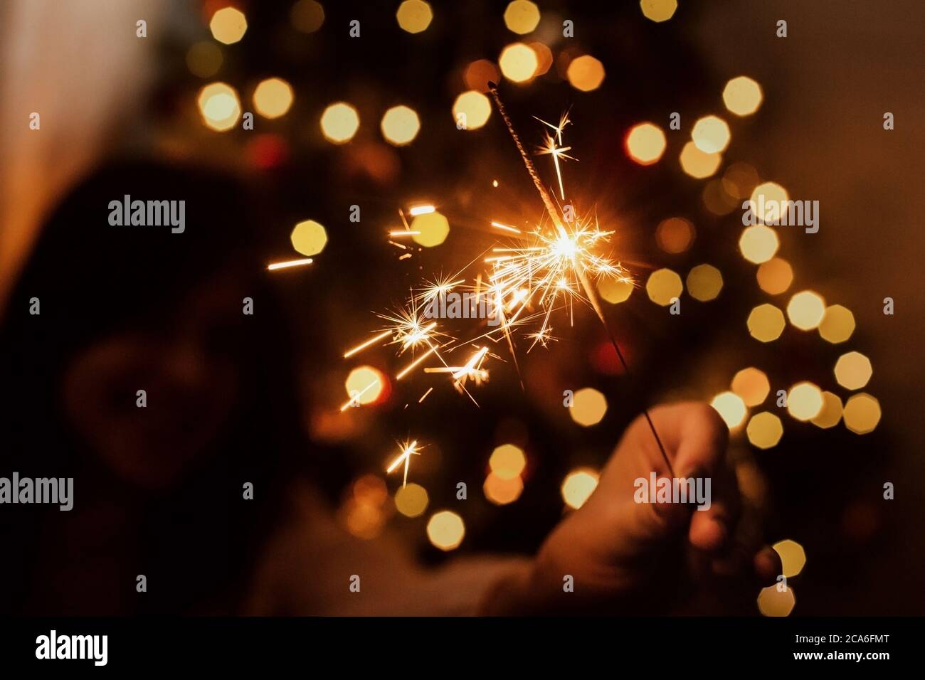 Happy New Year. Stylish girl with burning sparkler celebrating in ...