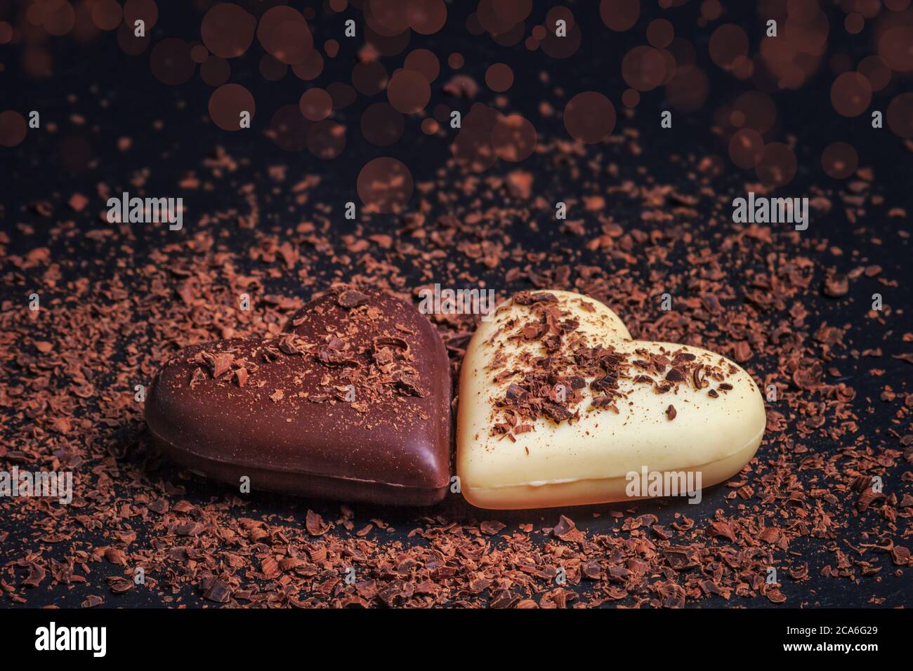 Two heart-shaped chocolates made of milk and white chocolate on the ...