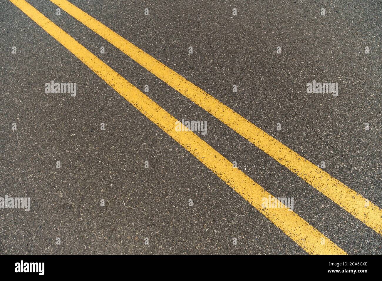 Double yellow lines on highway with summer sunlight Stock Photo - Alamy