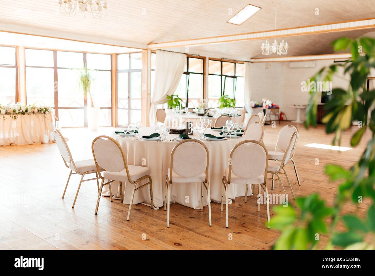 Round pink table with number three and setting up and chairs around it ...