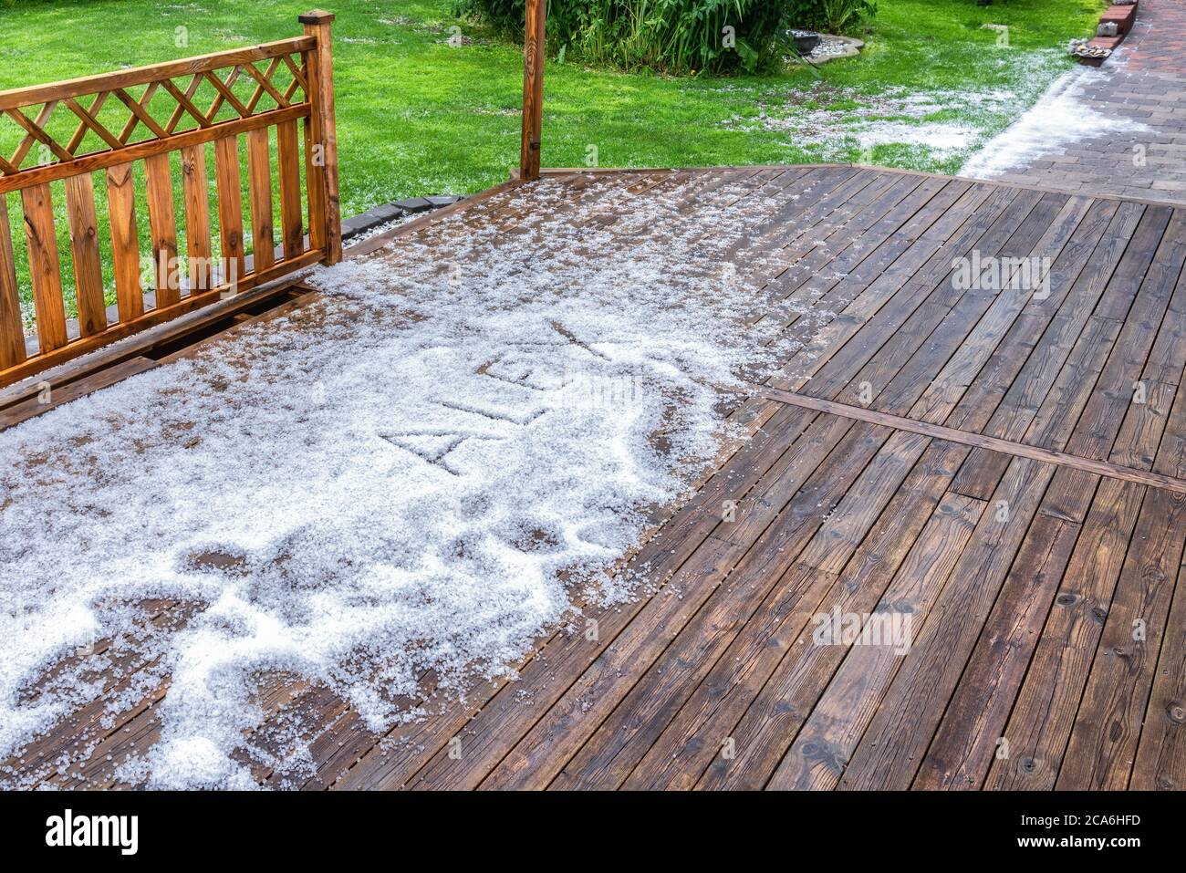 Name Alex is in capital letters is written on hail stones at wooden ...