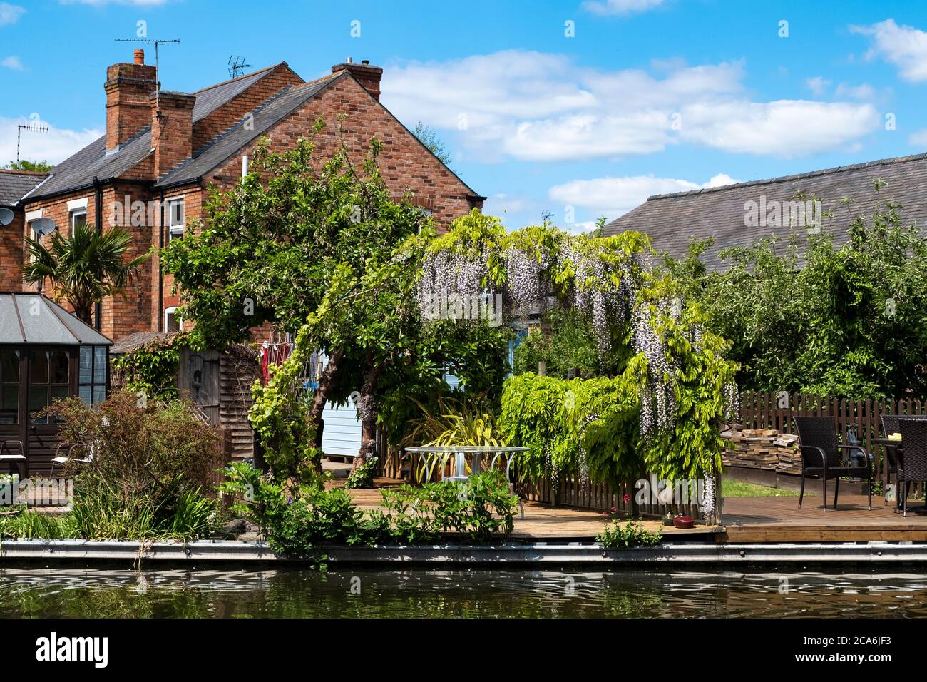 Canal side garden and seating area Stock Photo - Alamy