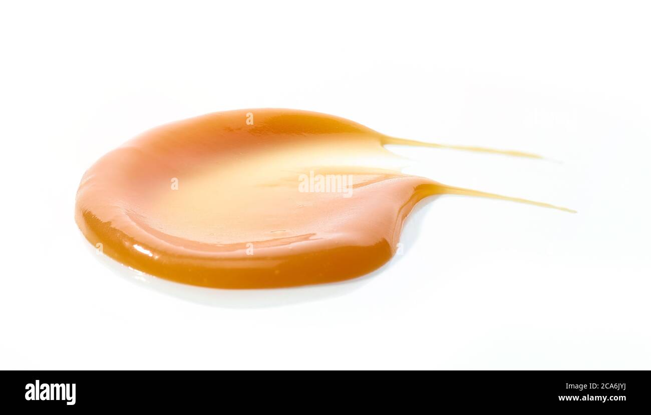 melted caramel drop isolated on white background Stock Photo - Alamy