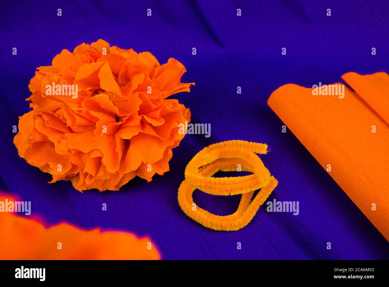 Materials needed to make a crepe paper flower, crepe paper and a pipe ...