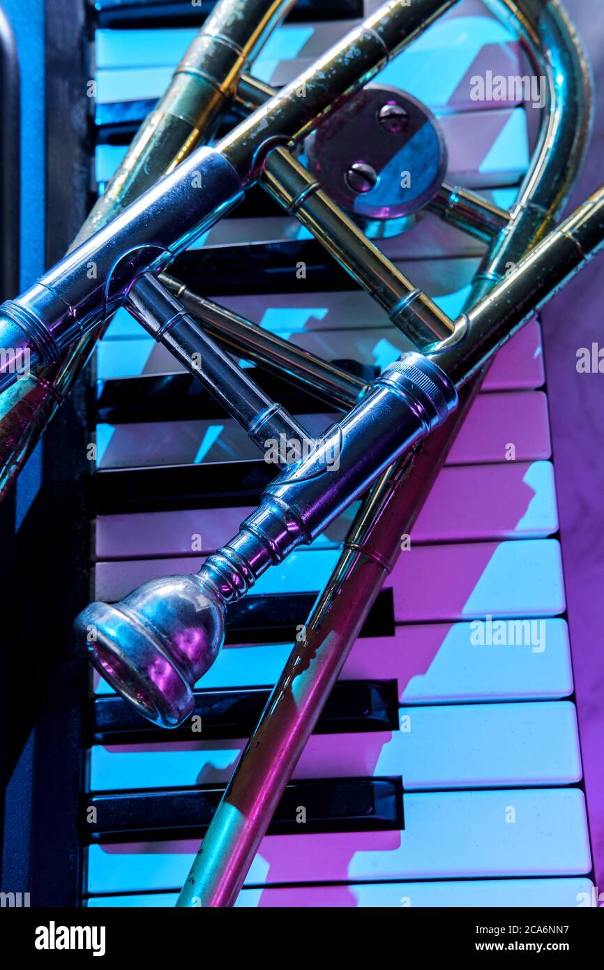 Old and worn Jazz slide trombone and piano keyboard musical show and ...