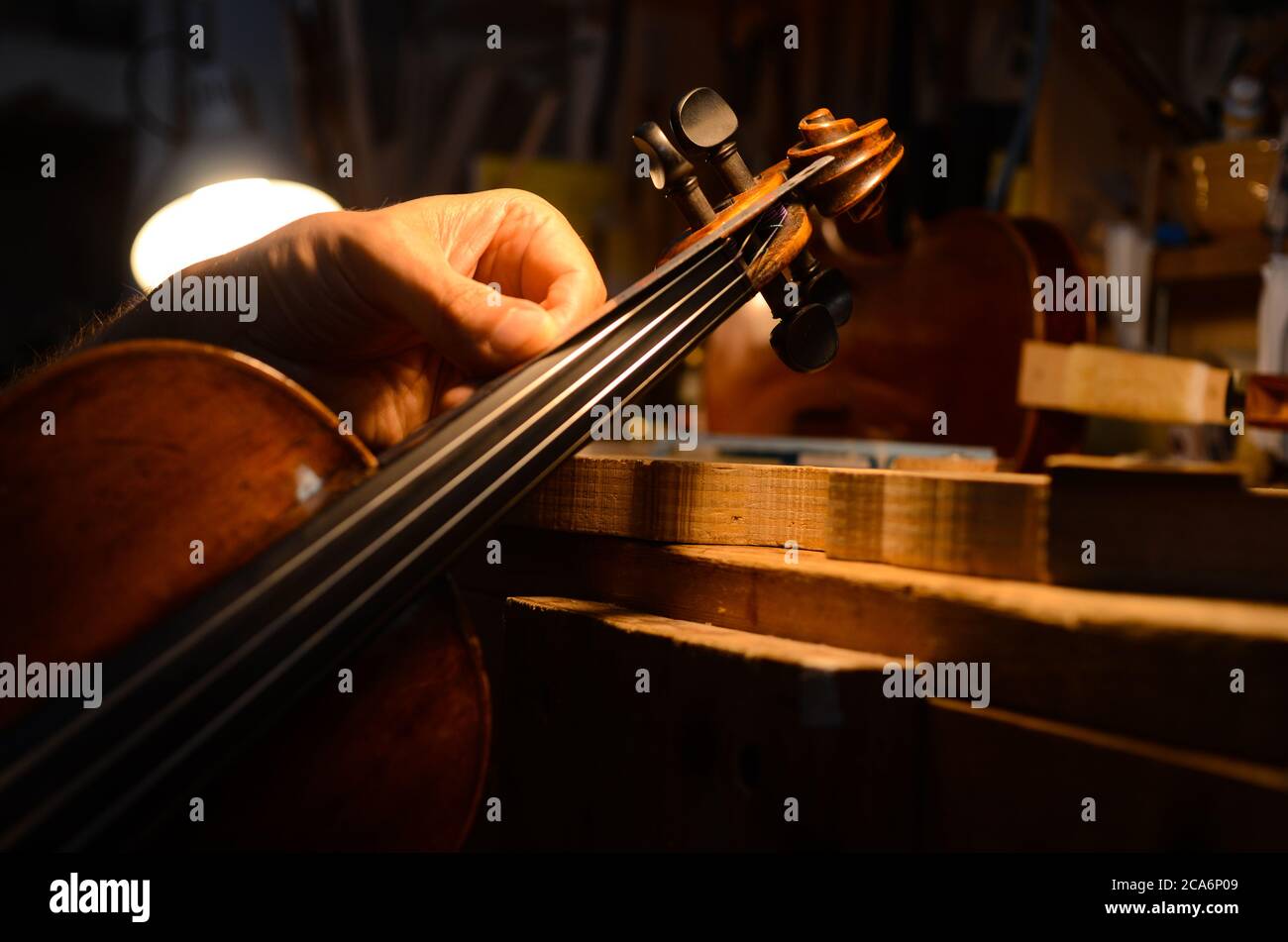 Luthier violin maker artisan setting up a violin in his workshop Stock ...