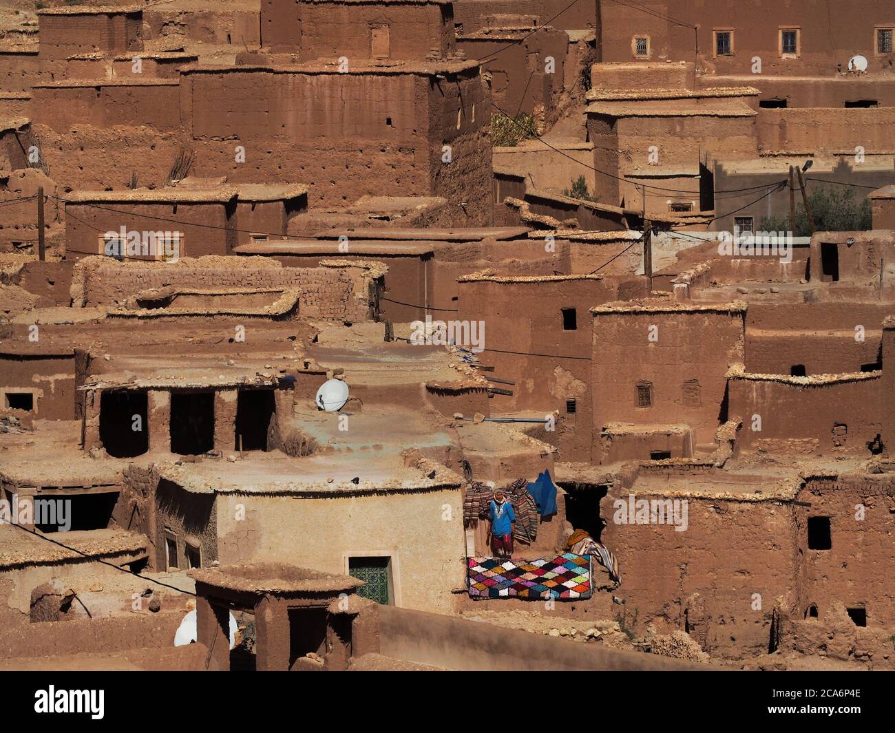Ancient Kasbah village of Tiger, bright blanket on the roof, Morocco ...