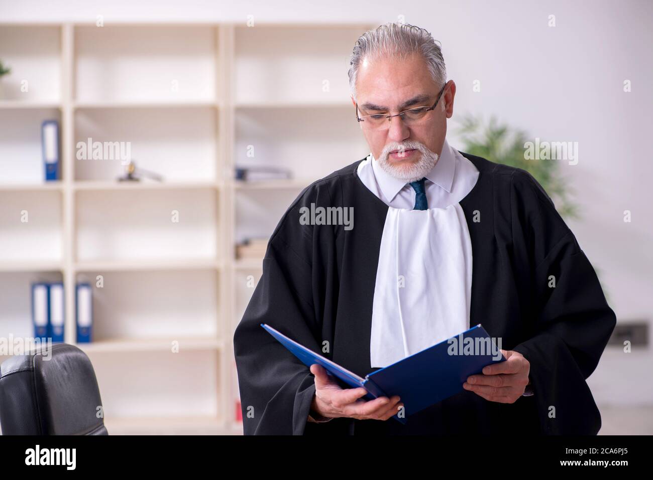Old judge working in courthouse Stock Photo - Alamy