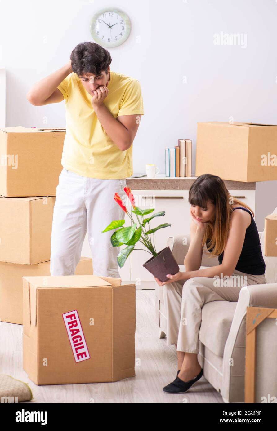 The young couple moving to new flat with fragile things Stock Photo - Alamy