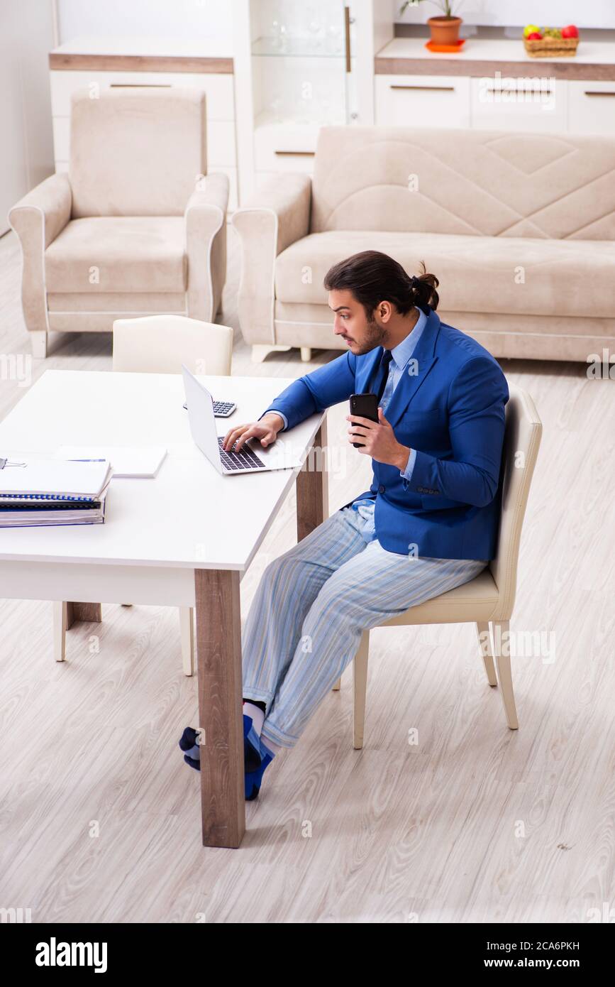 Young employee working from house in self-isolation concept Stock Photo ...
