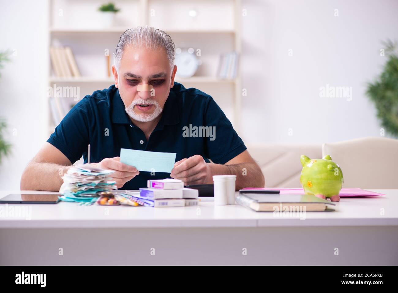 Old man in budget planning concept Stock Photo - Alamy