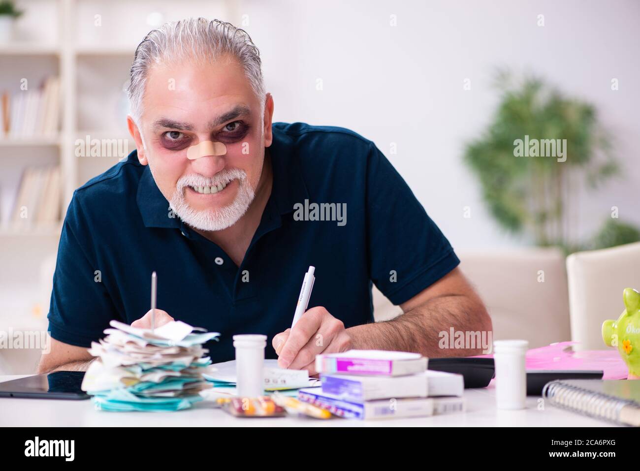 Old man in budget planning concept Stock Photo - Alamy