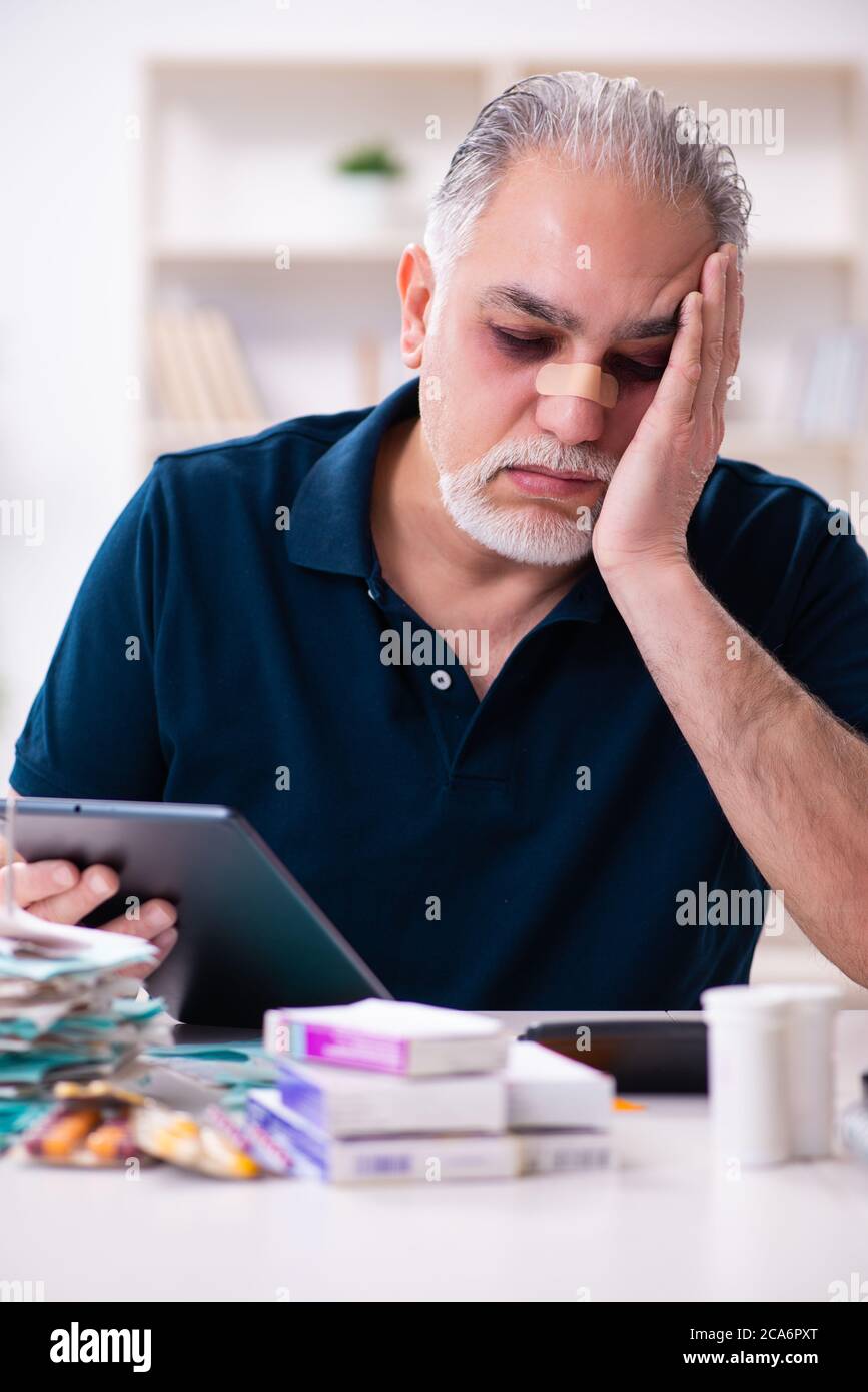 Old man in budget planning concept Stock Photo - Alamy