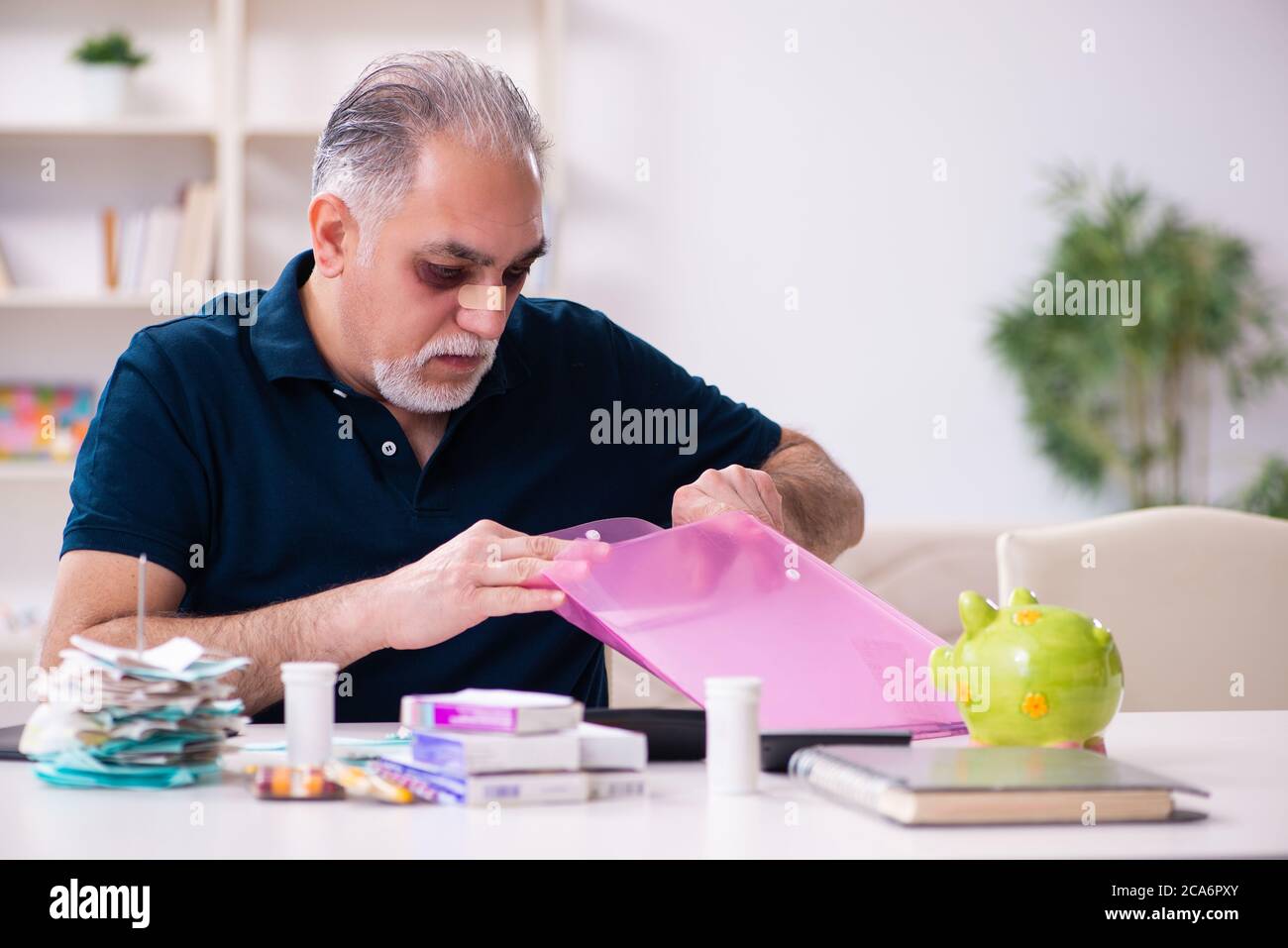 Old man in budget planning concept Stock Photo - Alamy