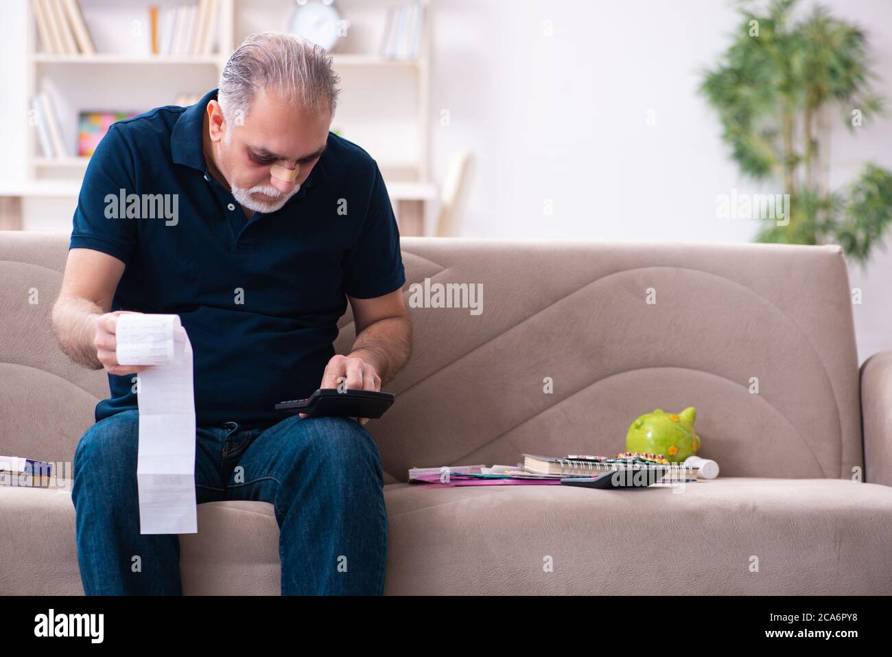 Old man in budget planning concept Stock Photo - Alamy
