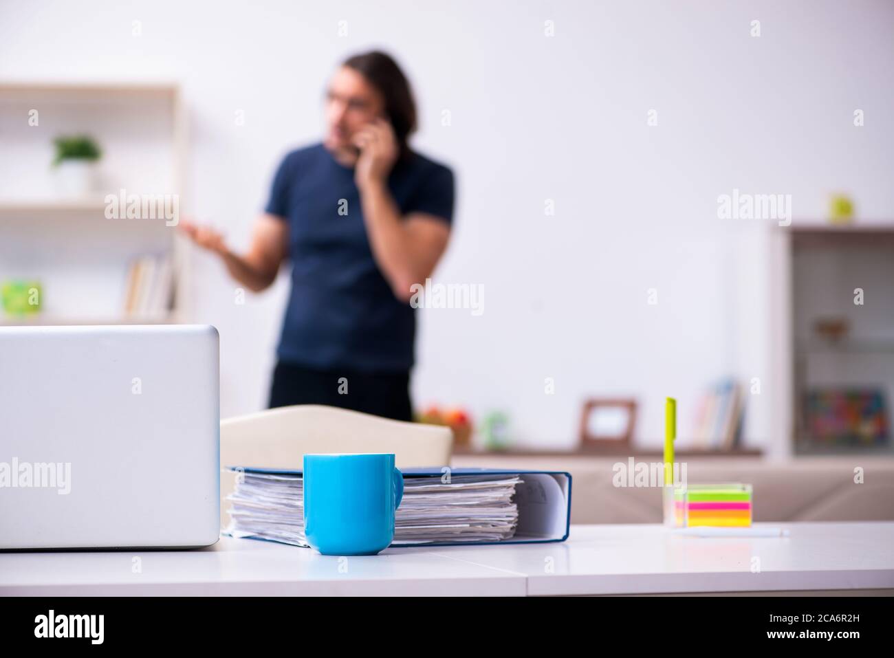 Young man employee working from home Stock Photo - Alamy