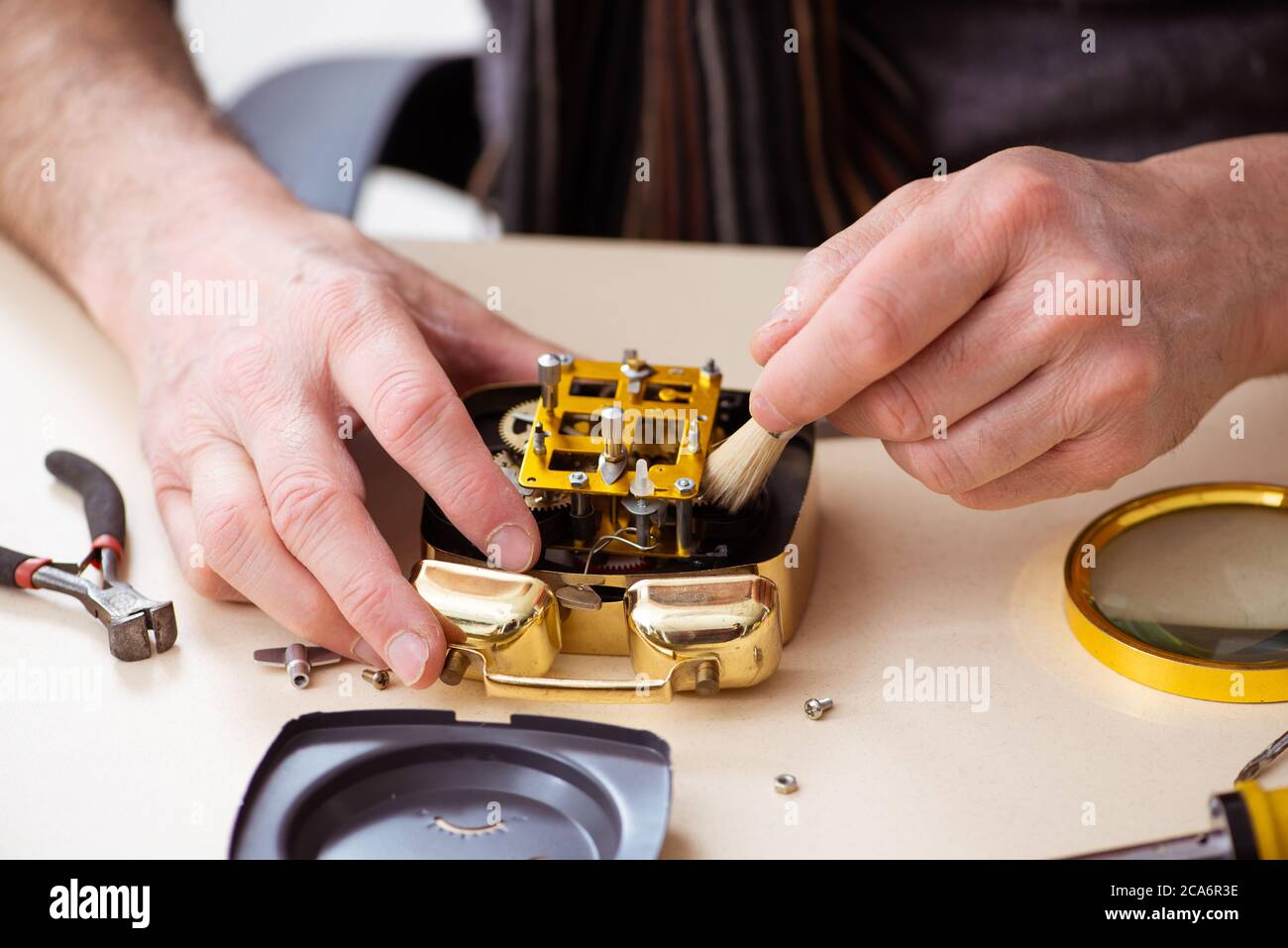 Old watchmaker working in the workshop Stock Photo - Alamy