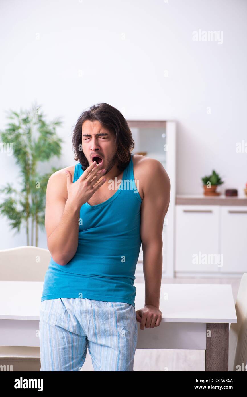 Young man waking up at the home Stock Photo - Alamy