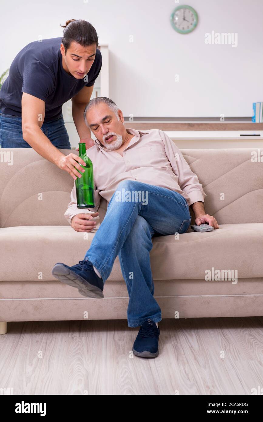 Drinking problems in the family between son and father Stock Photo - Alamy