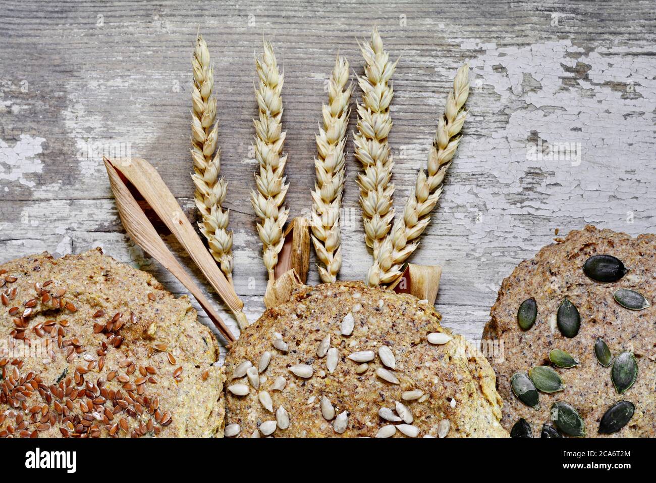 Different types of bread, flour and wheat on a wooden table Stock Photo ...