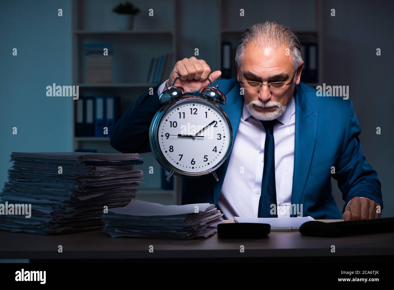 Old employee working late in the office Stock Photo - Alamy