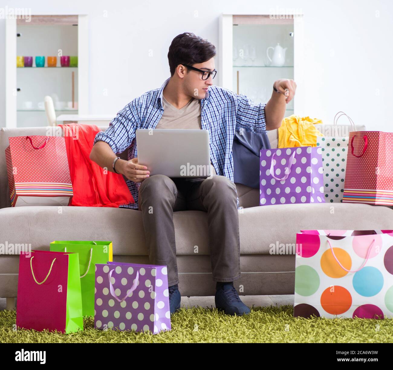 The young man buying clothing online and running blog Stock Photo - Alamy