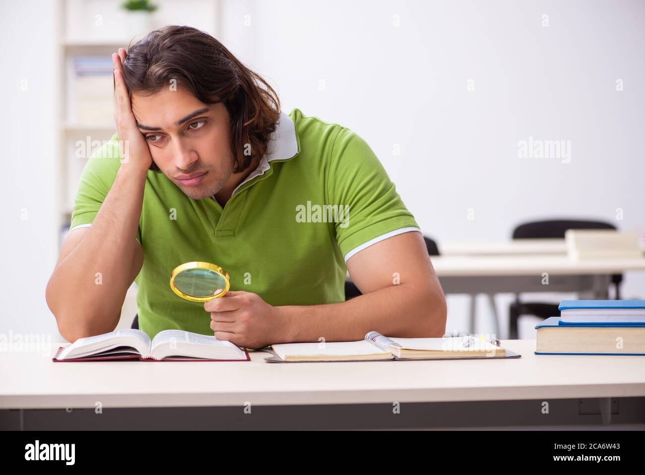 Young male student in the classroom studying Stock Photo - Alamy