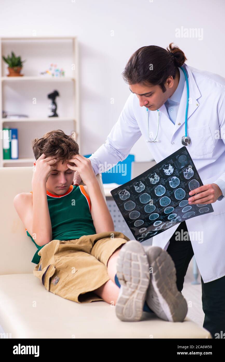 Sick boy visiting young doctor pediatrician Stock Photo - Alamy