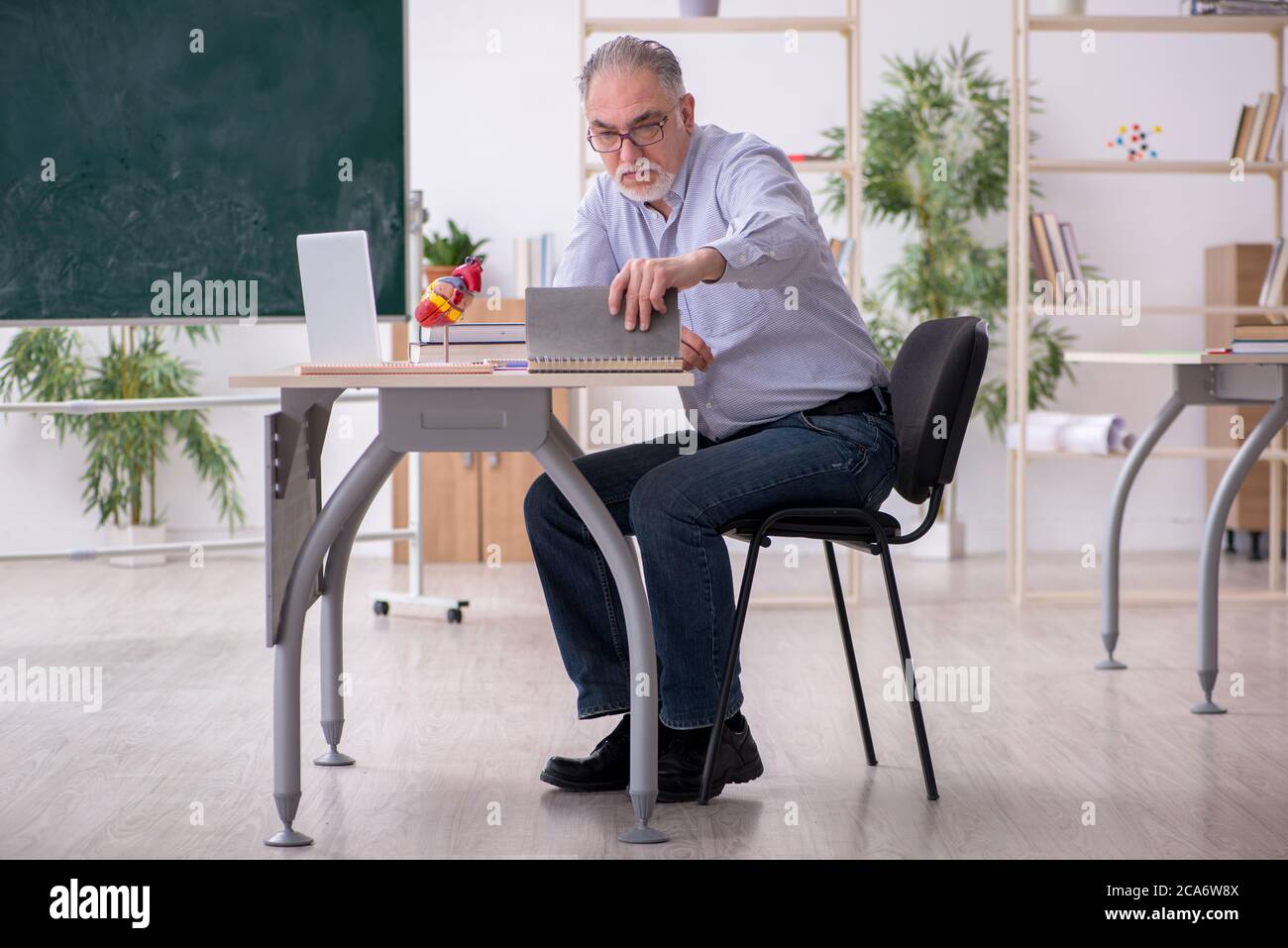 Old male teacher in the school classroom Stock Photo - Alamy