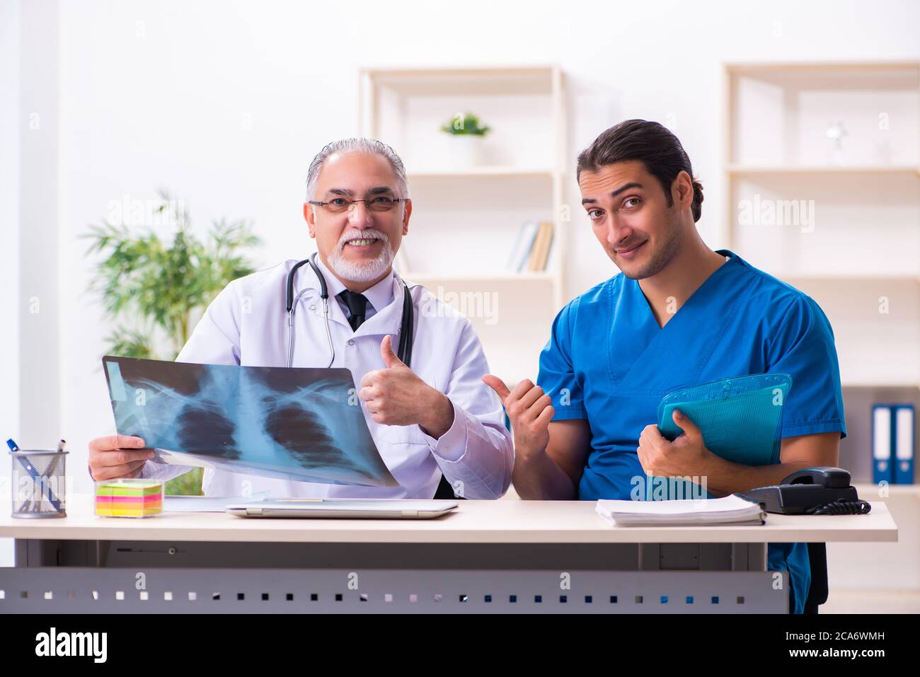 Two male doctors working in the modern clinic Stock Photo - Alamy