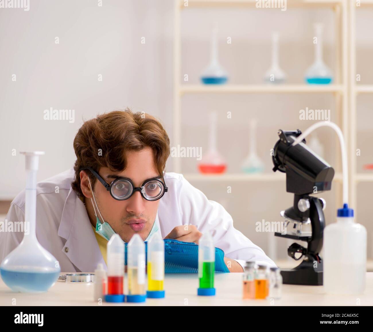 The funny crazy chemist doing experiments and tests Stock Photo - Alamy