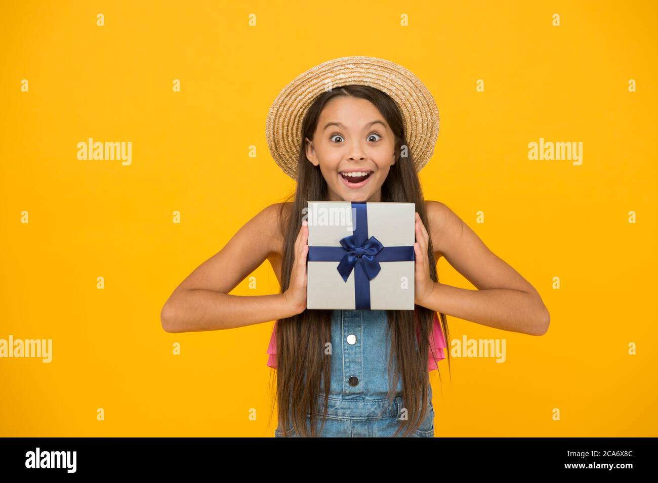 Its time for surprise. Happy girl hold gift yellow background. Surprise ...
