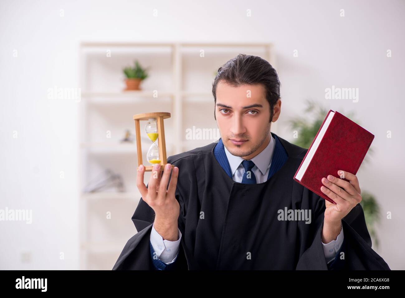 Young judge in time management concept Stock Photo - Alamy