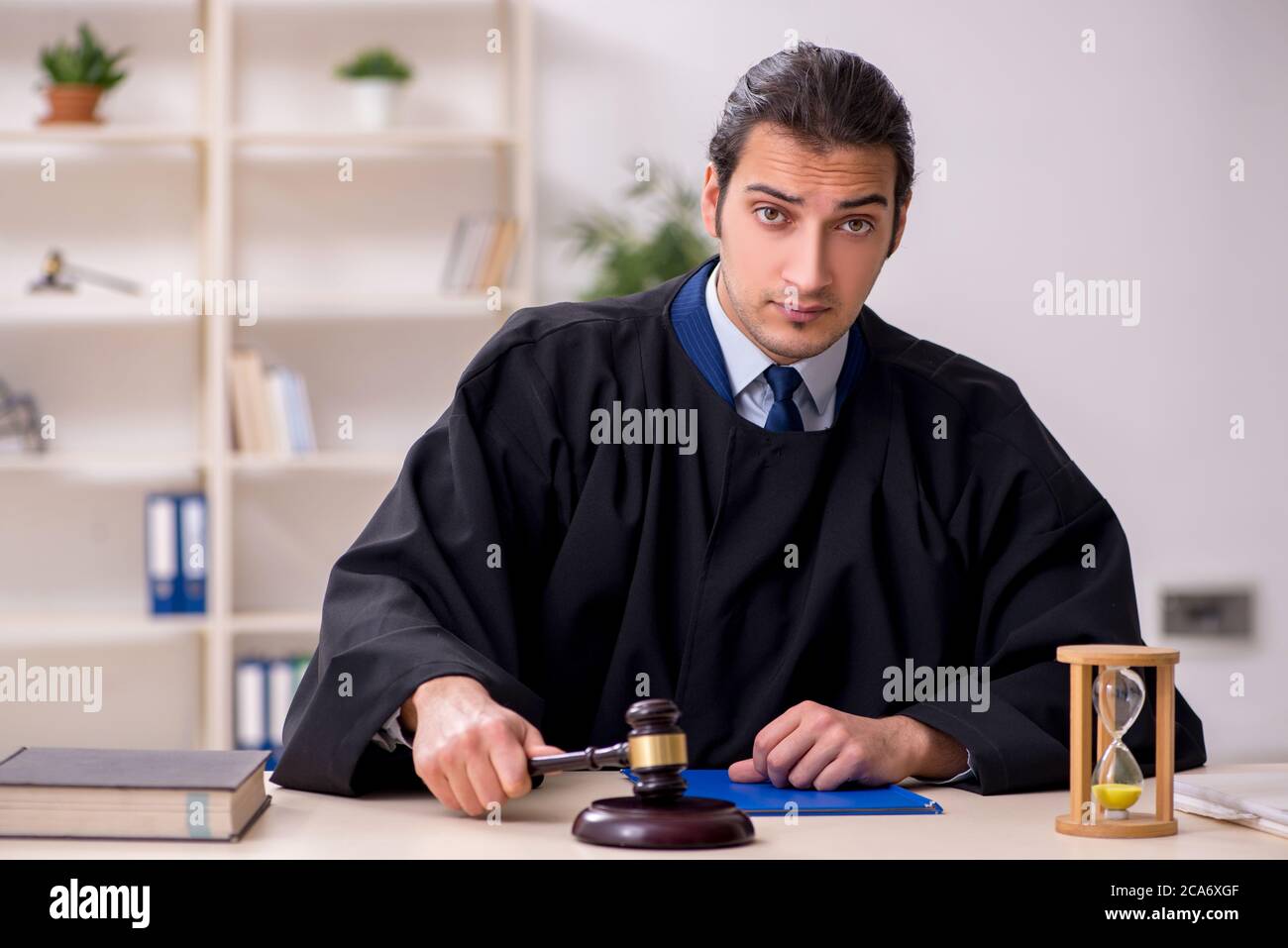 Young judge in time management concept Stock Photo - Alamy