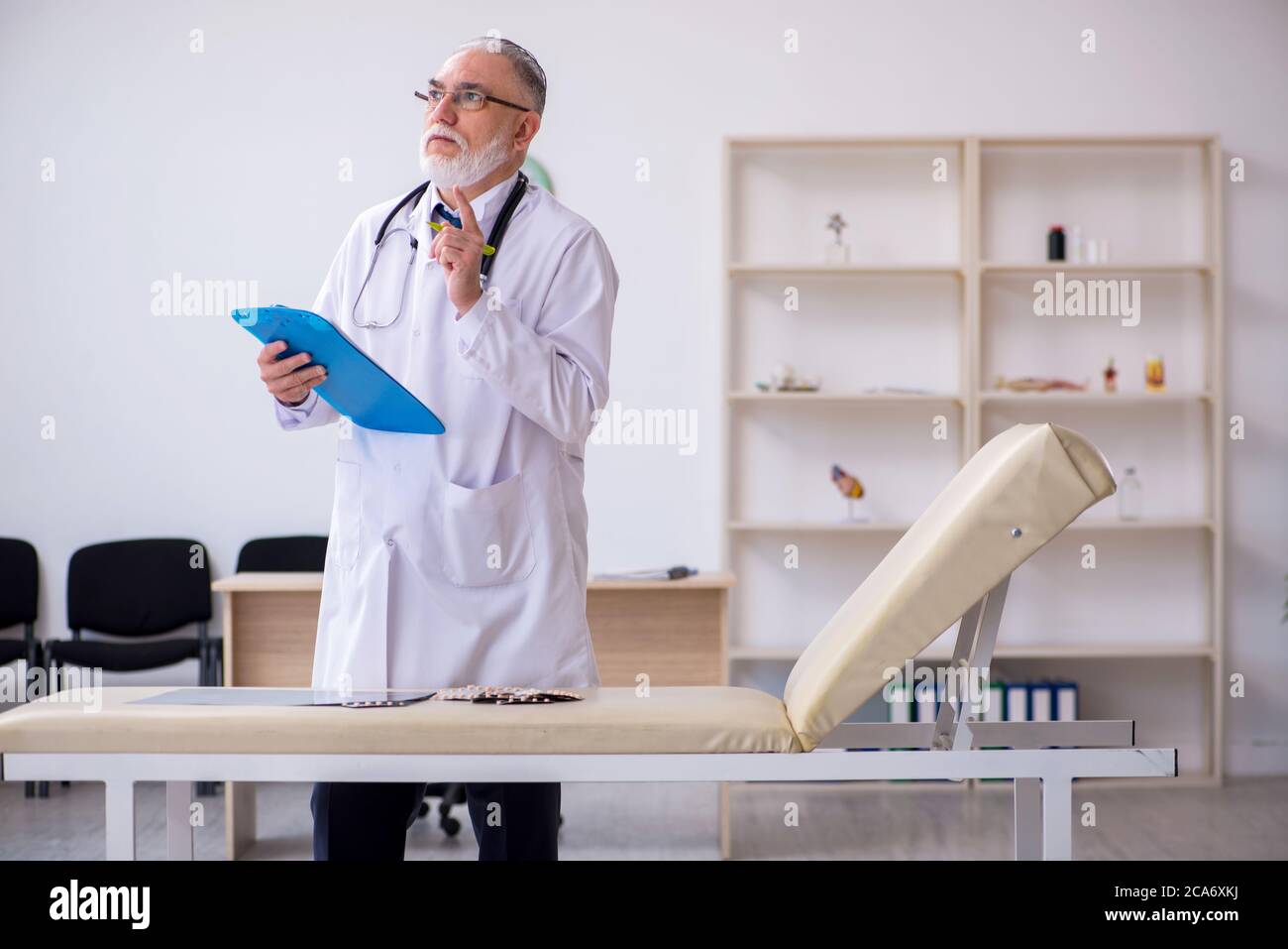 Focused senior old doctor working hi-res stock photography and images ...