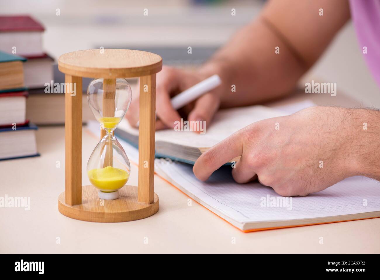 Young student in the classroom at time management concept Stock Photo ...