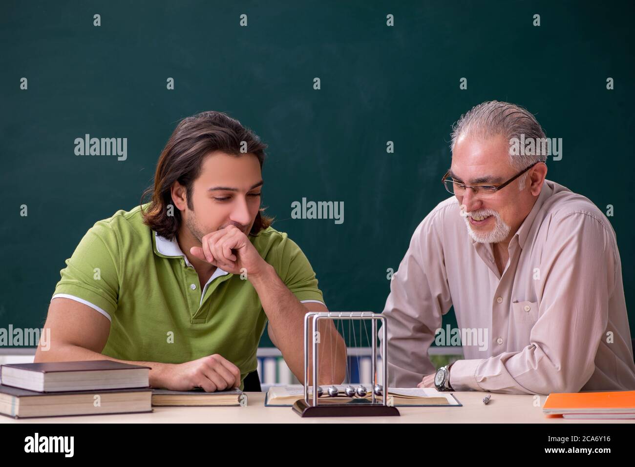 Old professor physicist and student in the classroom Stock Photo - Alamy