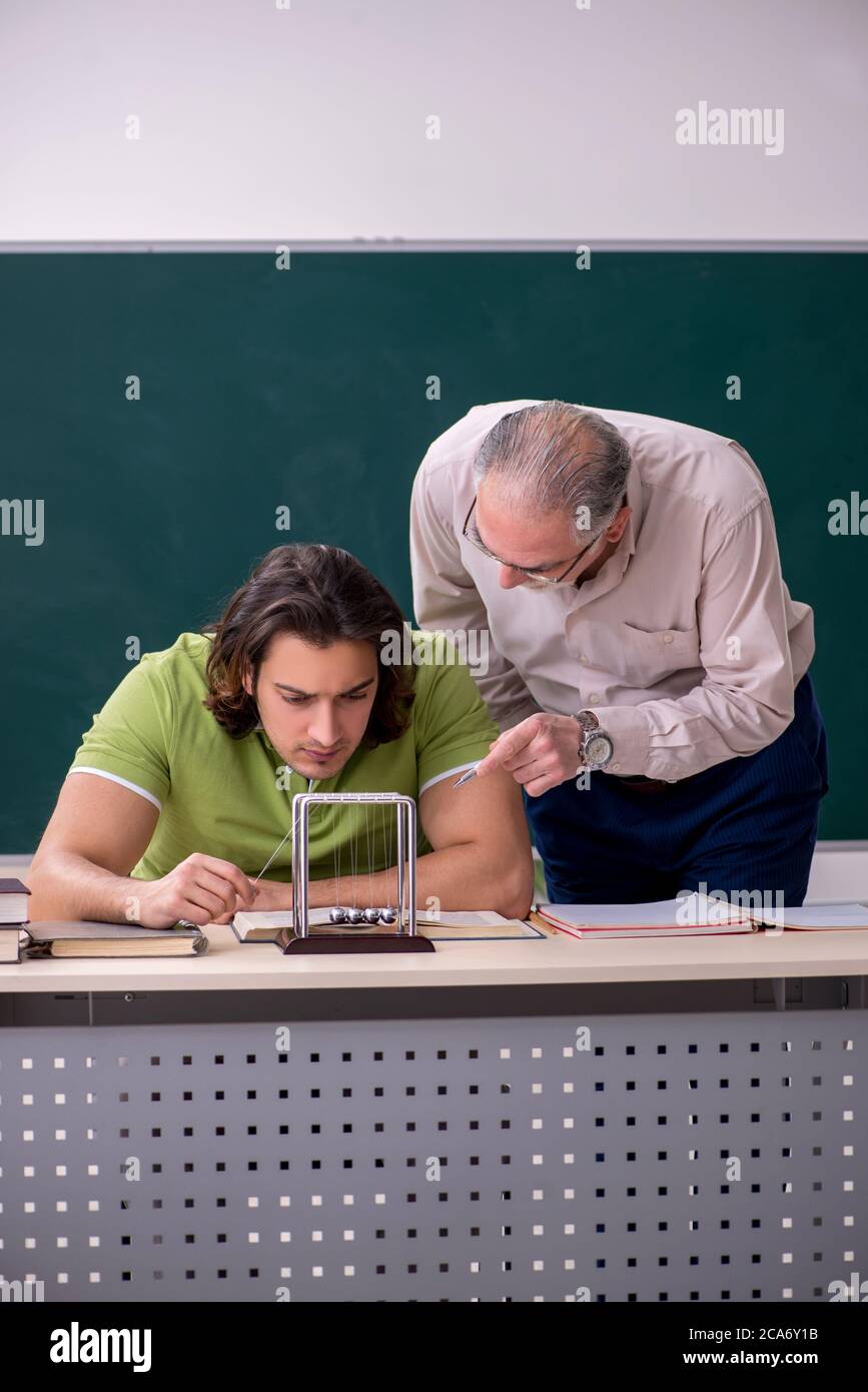 Old professor physicist and student in the classroom Stock Photo - Alamy