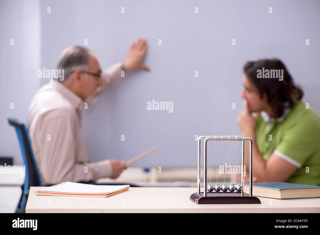 Old professor physicist and student in the classroom Stock Photo - Alamy