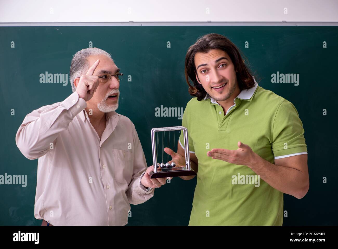 Old professor physicist and student in the classroom Stock Photo - Alamy