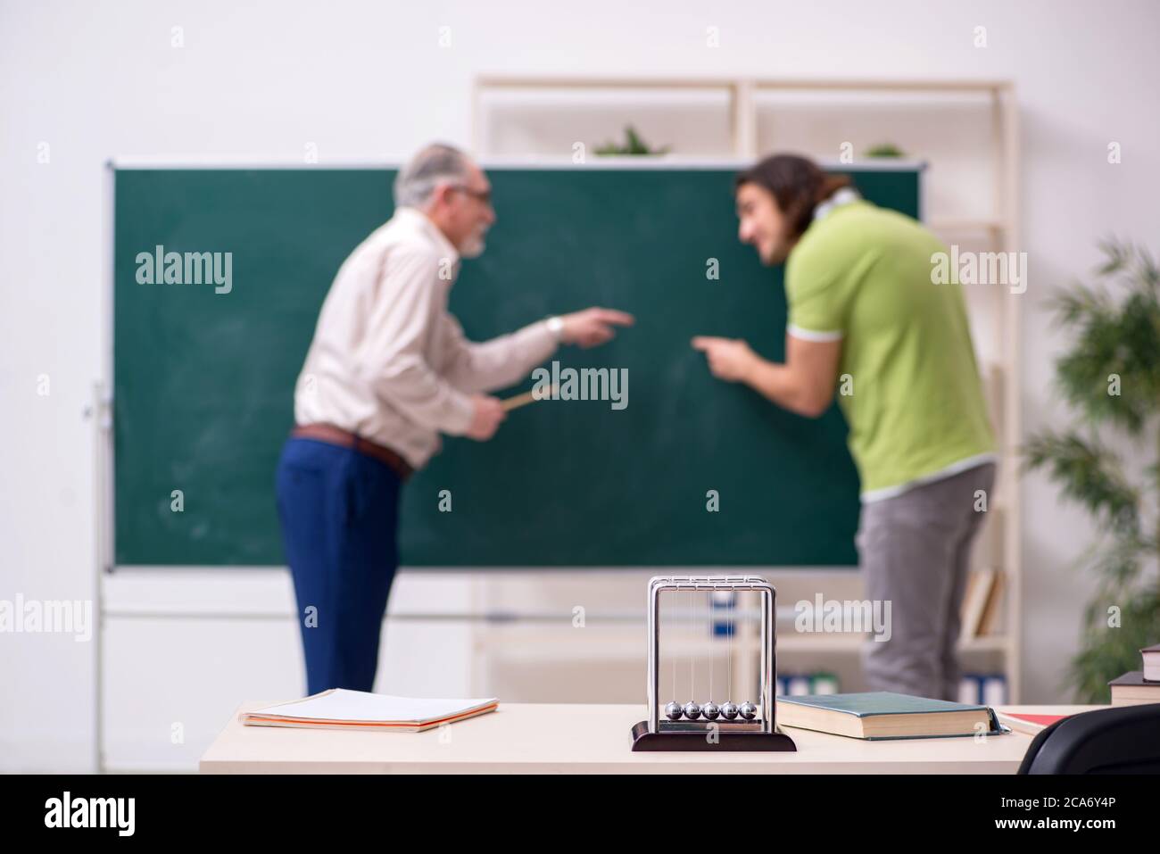 Old professor physicist and student in the classroom Stock Photo - Alamy