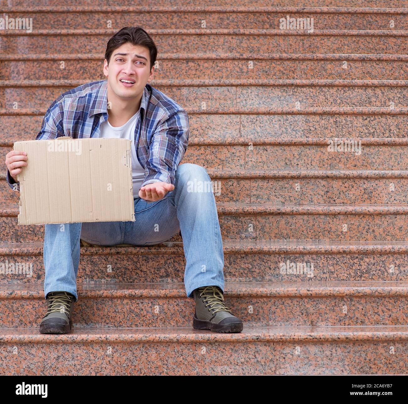 The young man begging money on the street Stock Photo - Alamy