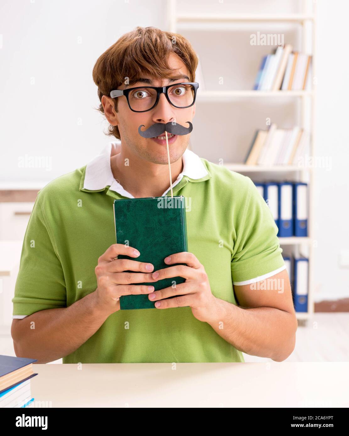 The student with fake moustache reading book Stock Photo - Alamy