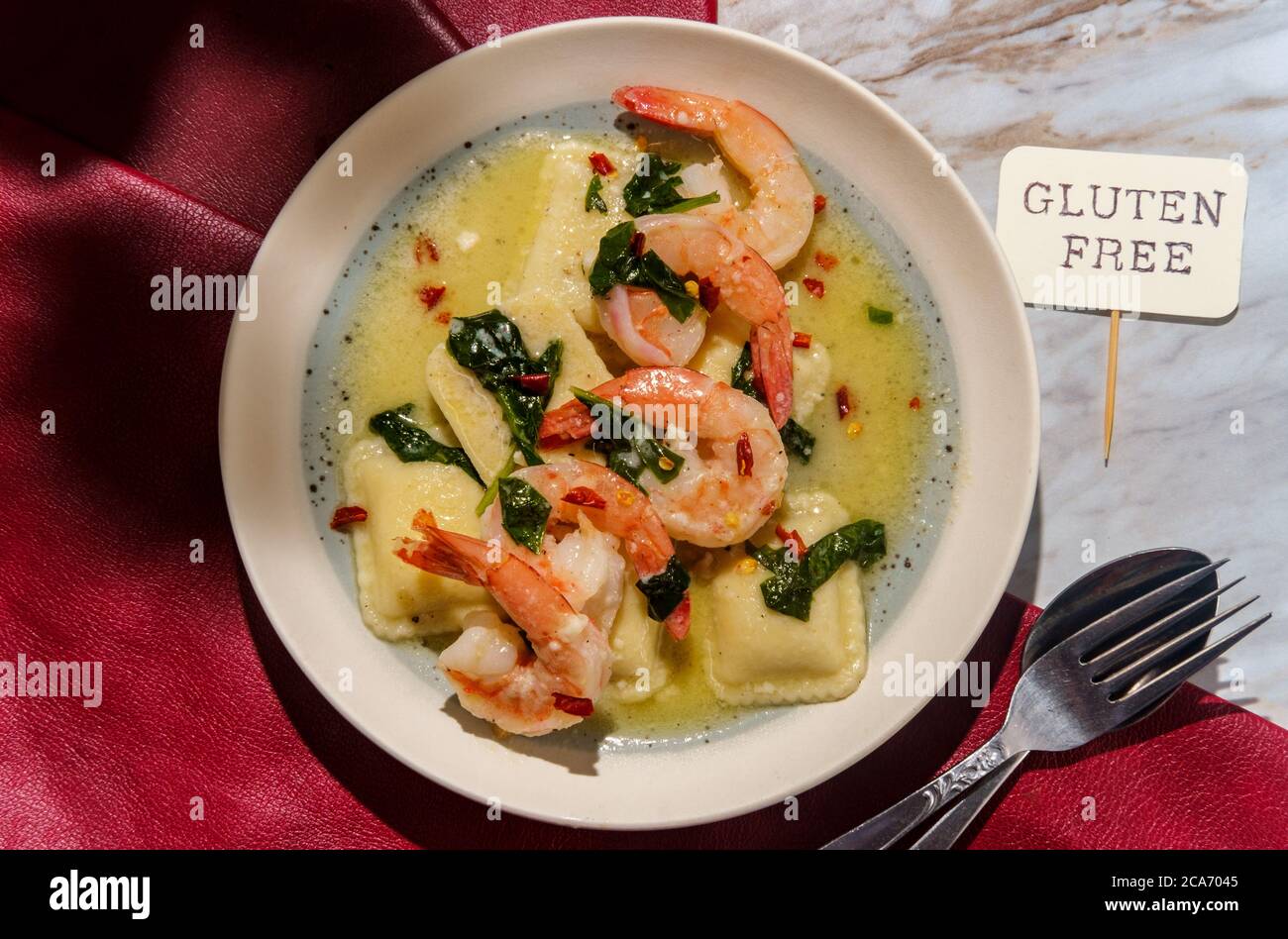 Tuscan creamy shrimp and cheese ravioli with spinach Stock Photo - Alamy