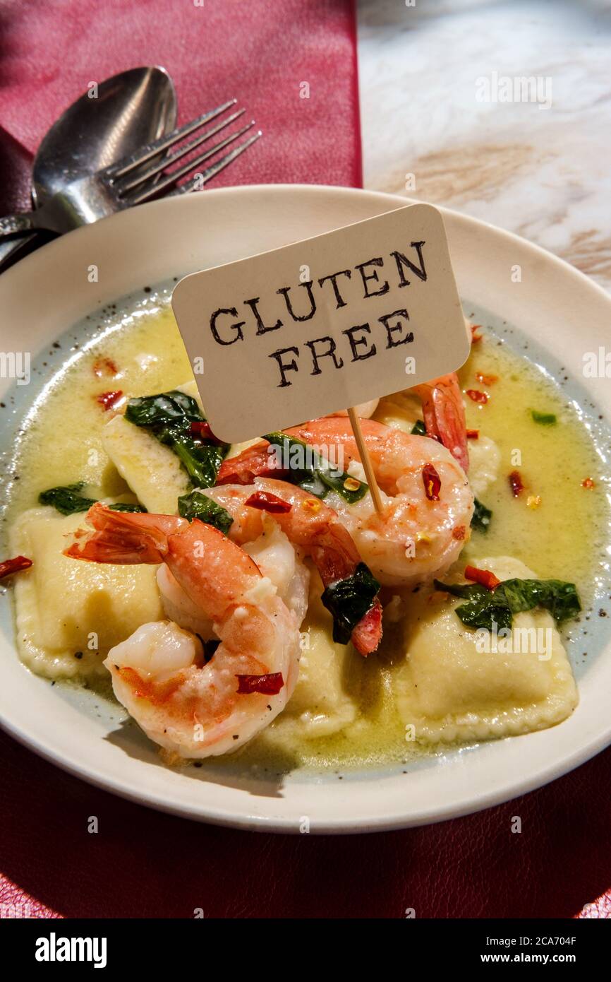 Tuscan creamy shrimp and cheese ravioli with spinach Stock Photo - Alamy