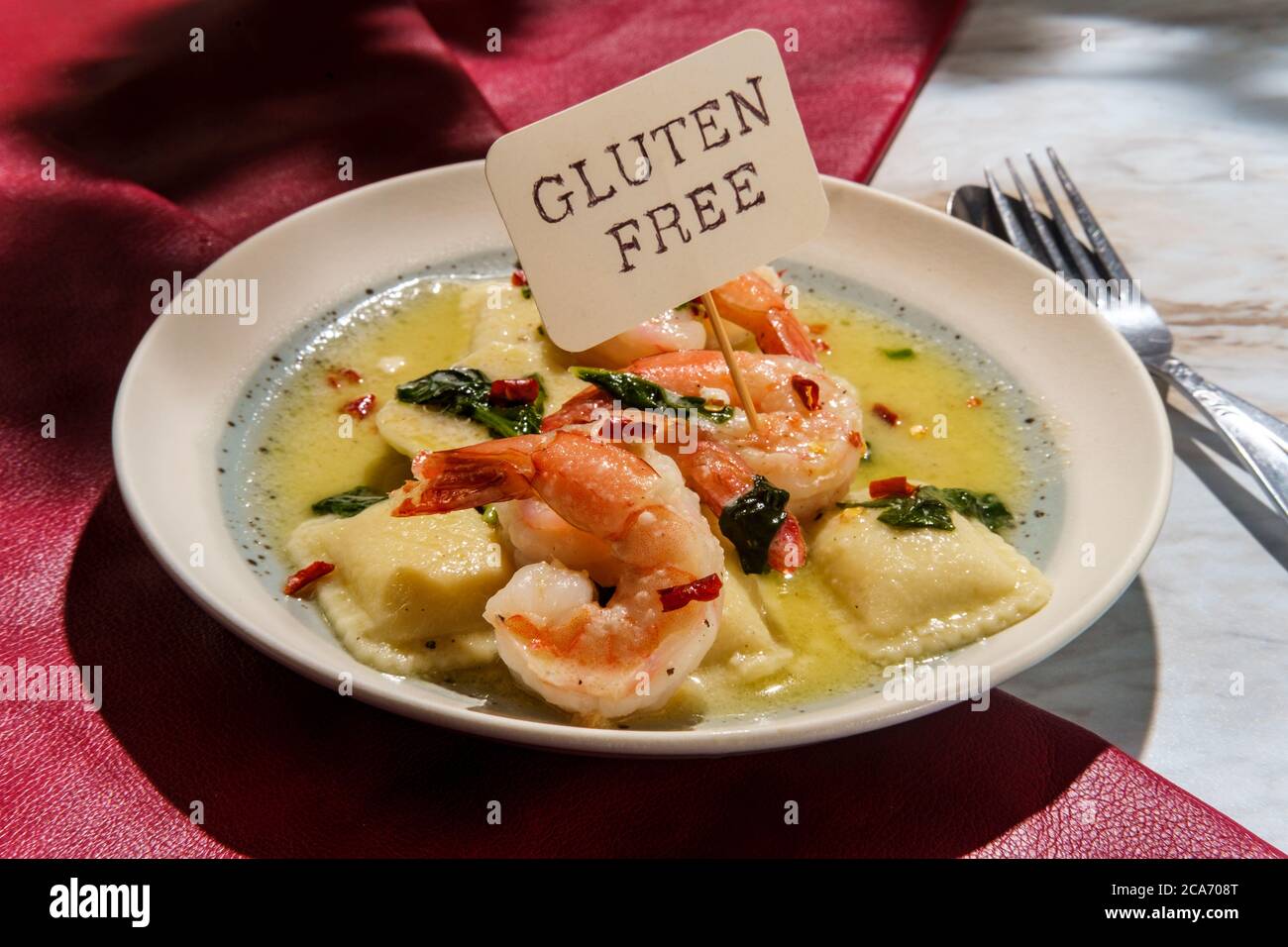 Tuscan creamy shrimp and cheese ravioli with spinach Stock Photo - Alamy