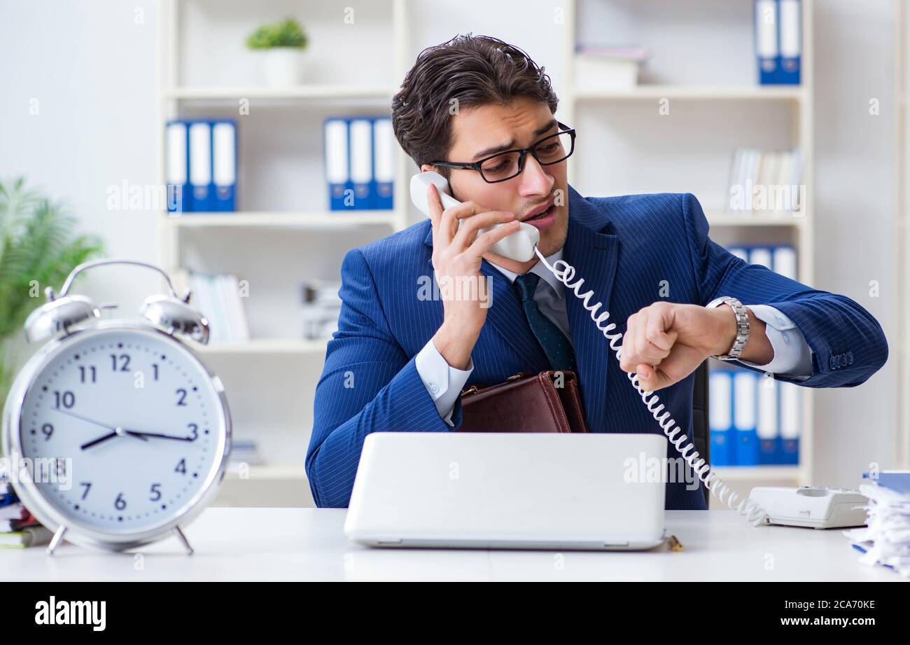 The businessman in bad time management concept Stock Photo - Alamy