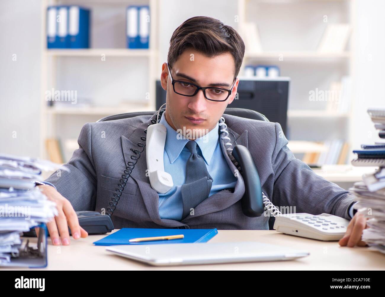 The desperate sad employee tired at his desk in call center Stock Photo ...