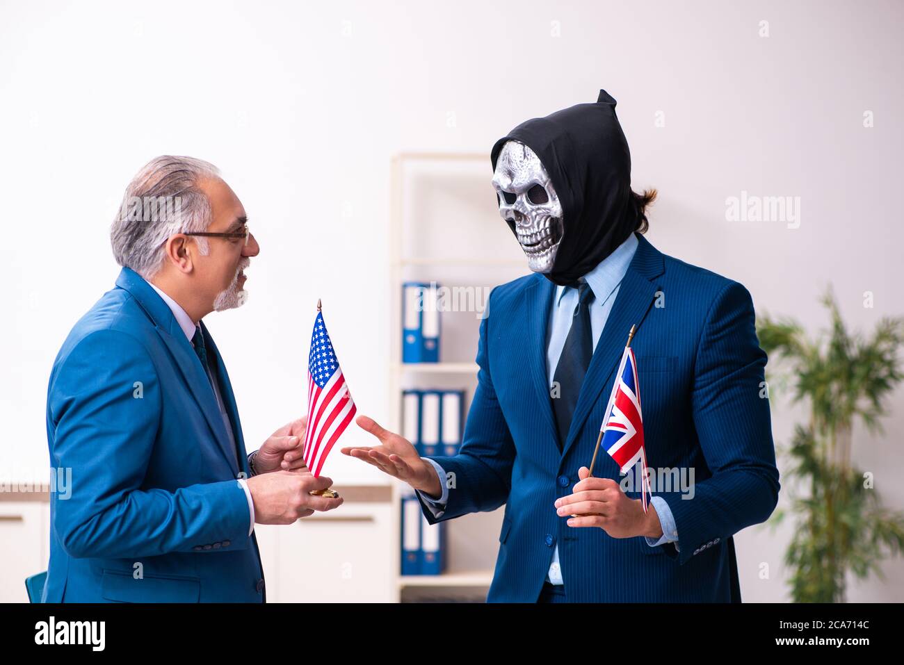 Old businessman employee making deal with the devil Stock Photo - Alamy