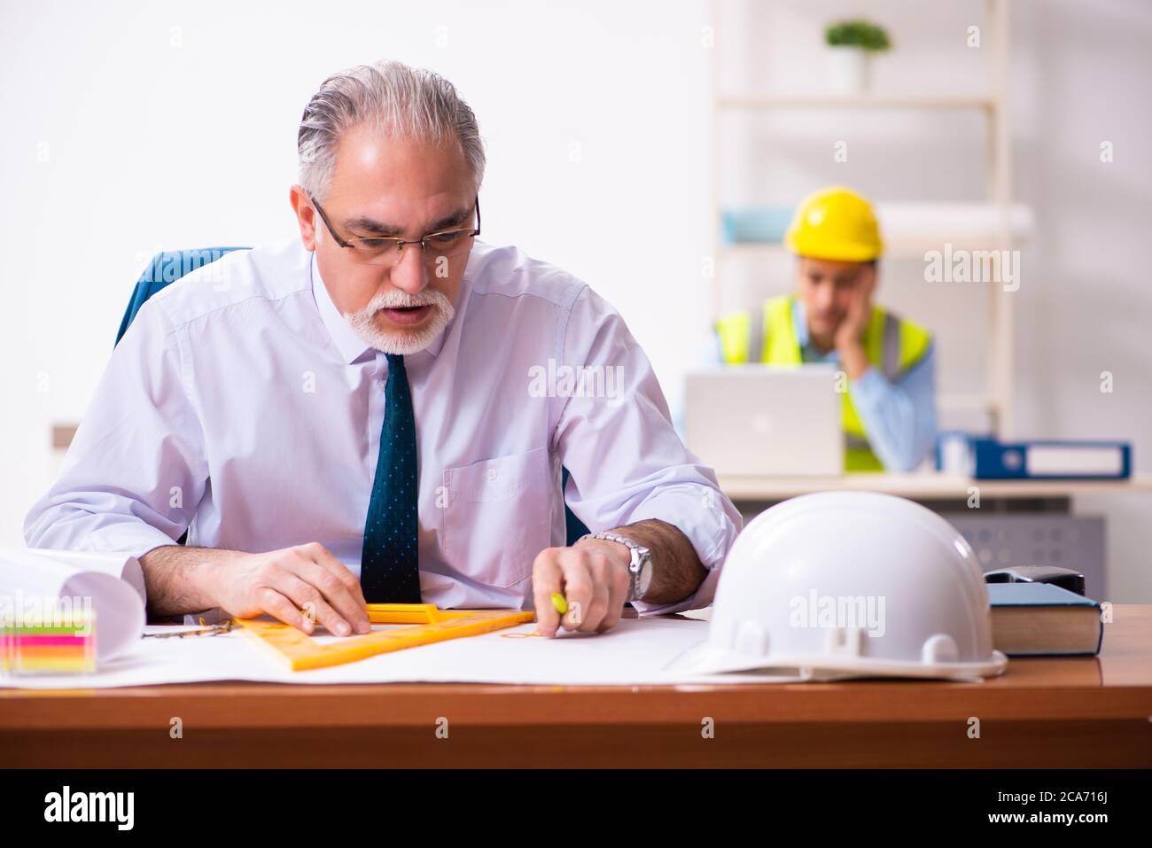 Two architects working in the office Stock Photo - Alamy